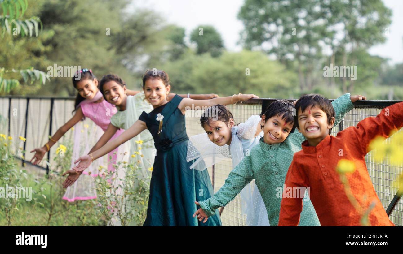 Group of happy playful Indian children playing outdoors in spring park ...