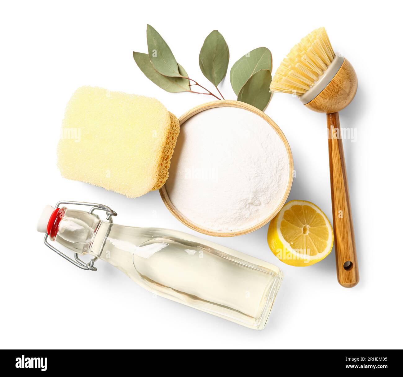 Bowl of baking soda, vinegar, cleaning brush, sponge and lemon on white ...