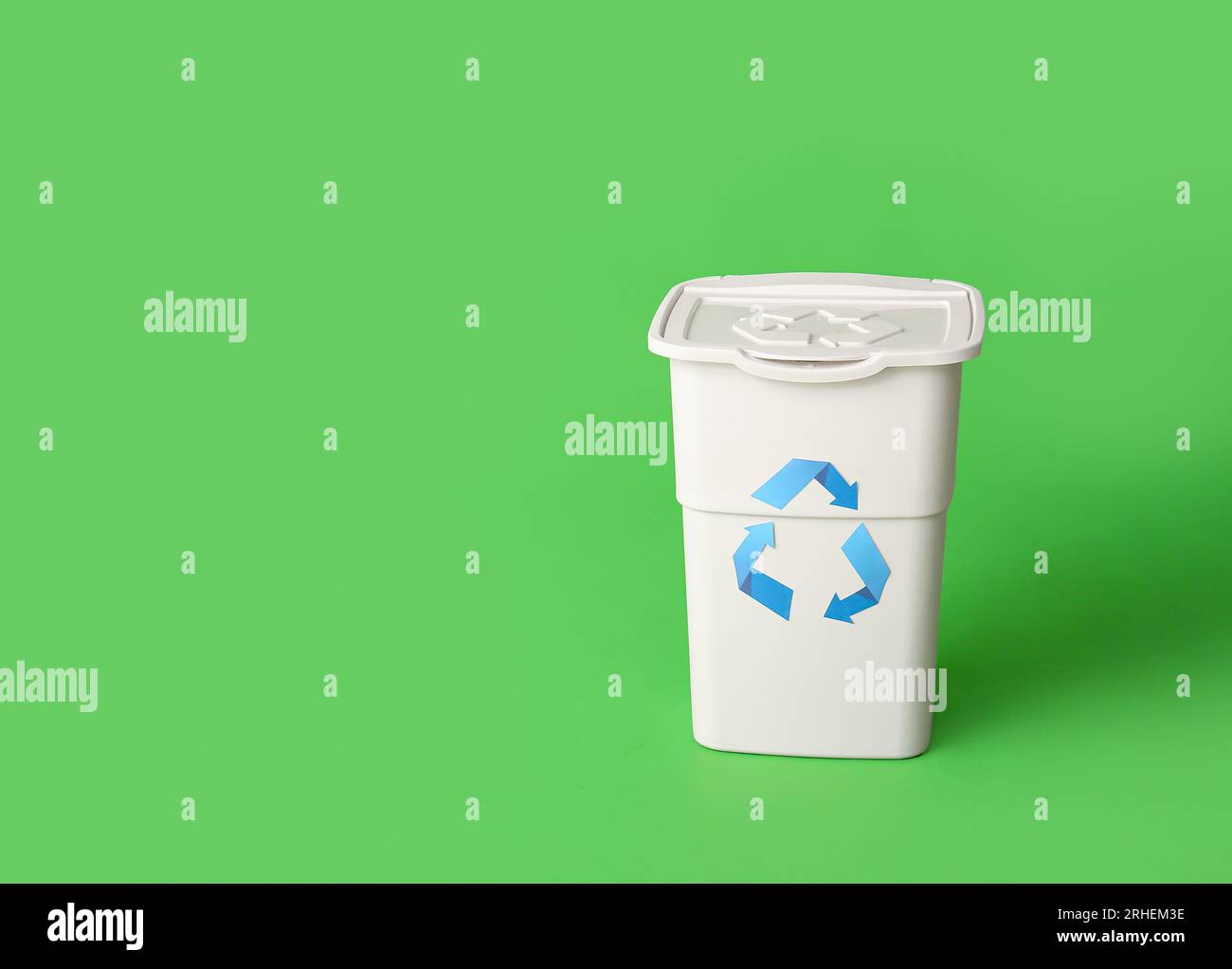 Container for garbage on green background. Recycling concept Stock ...