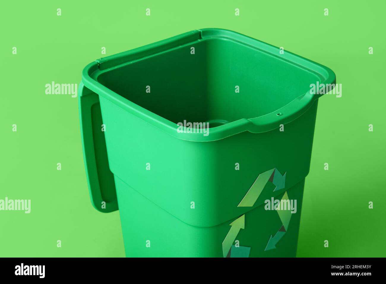 Container for garbage on green background. Recycling concept Stock ...