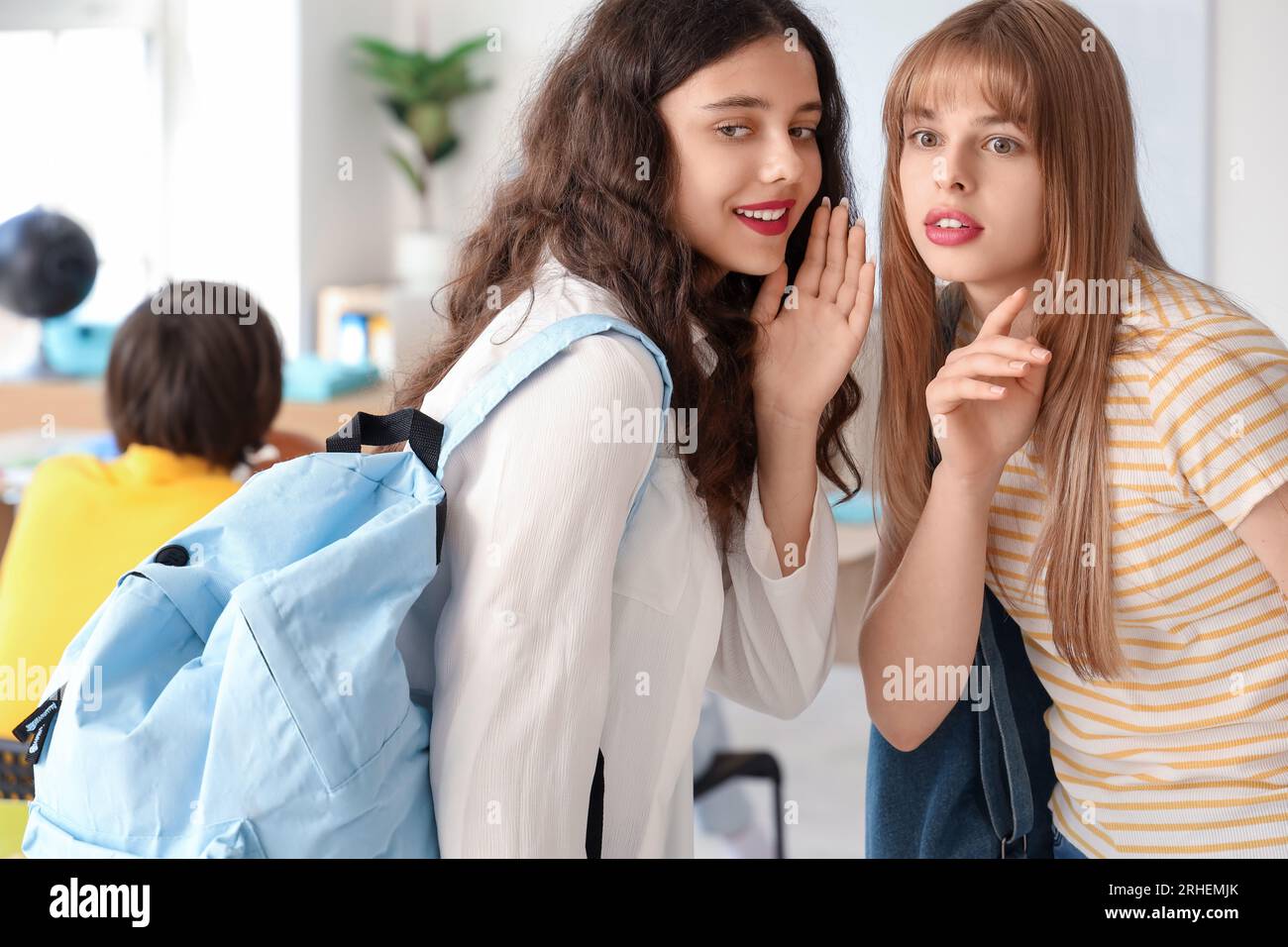 Female students gossiping in classroom Stock Photo - Alamy