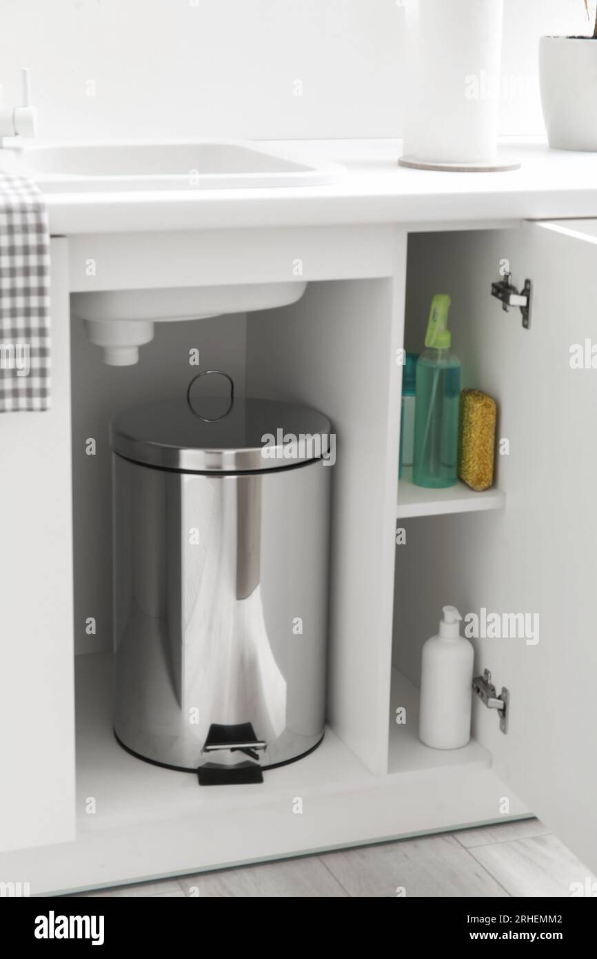 Metallic trash bin inside white counter in modern kitchen Stock Photo ...