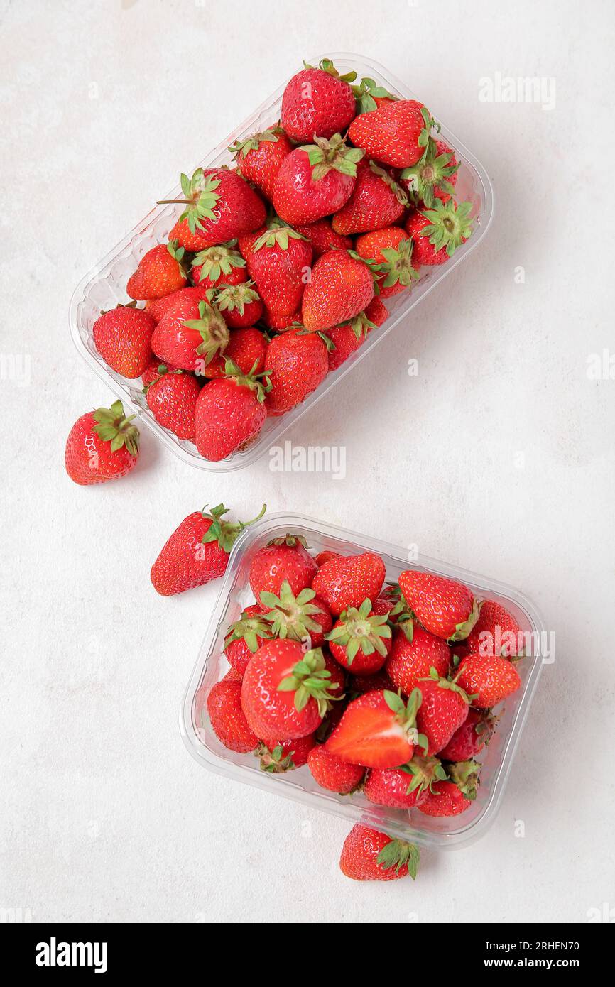 Plastic containers with fresh strawberry on white background Stock ...