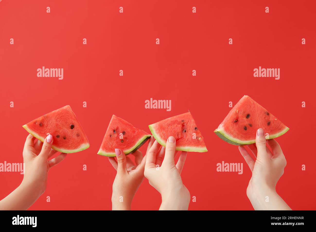 Female hands with pieces of ripe watermelon on red background Stock ...