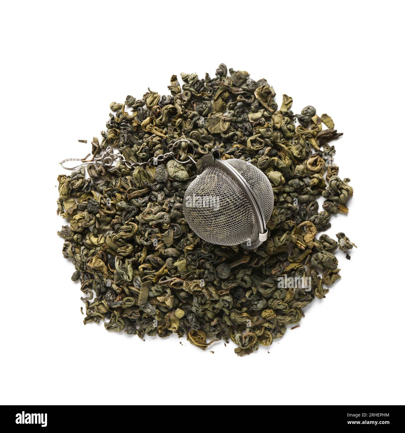 Metal infuser with green tea leaves on white background Stock Photo - Alamy