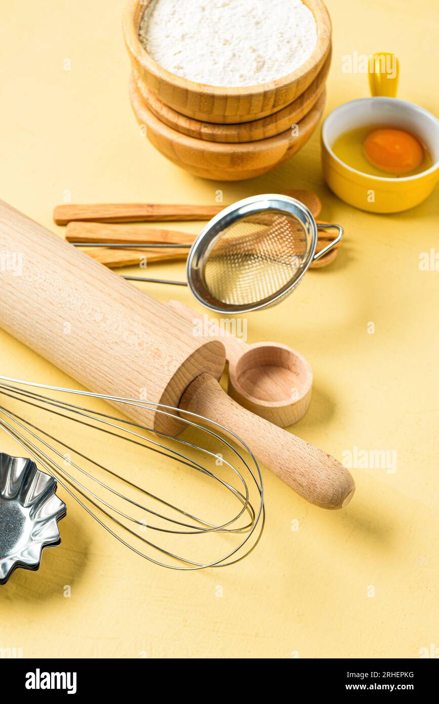 Set of baking ingredients and utensils on beige background Stock Photo ...