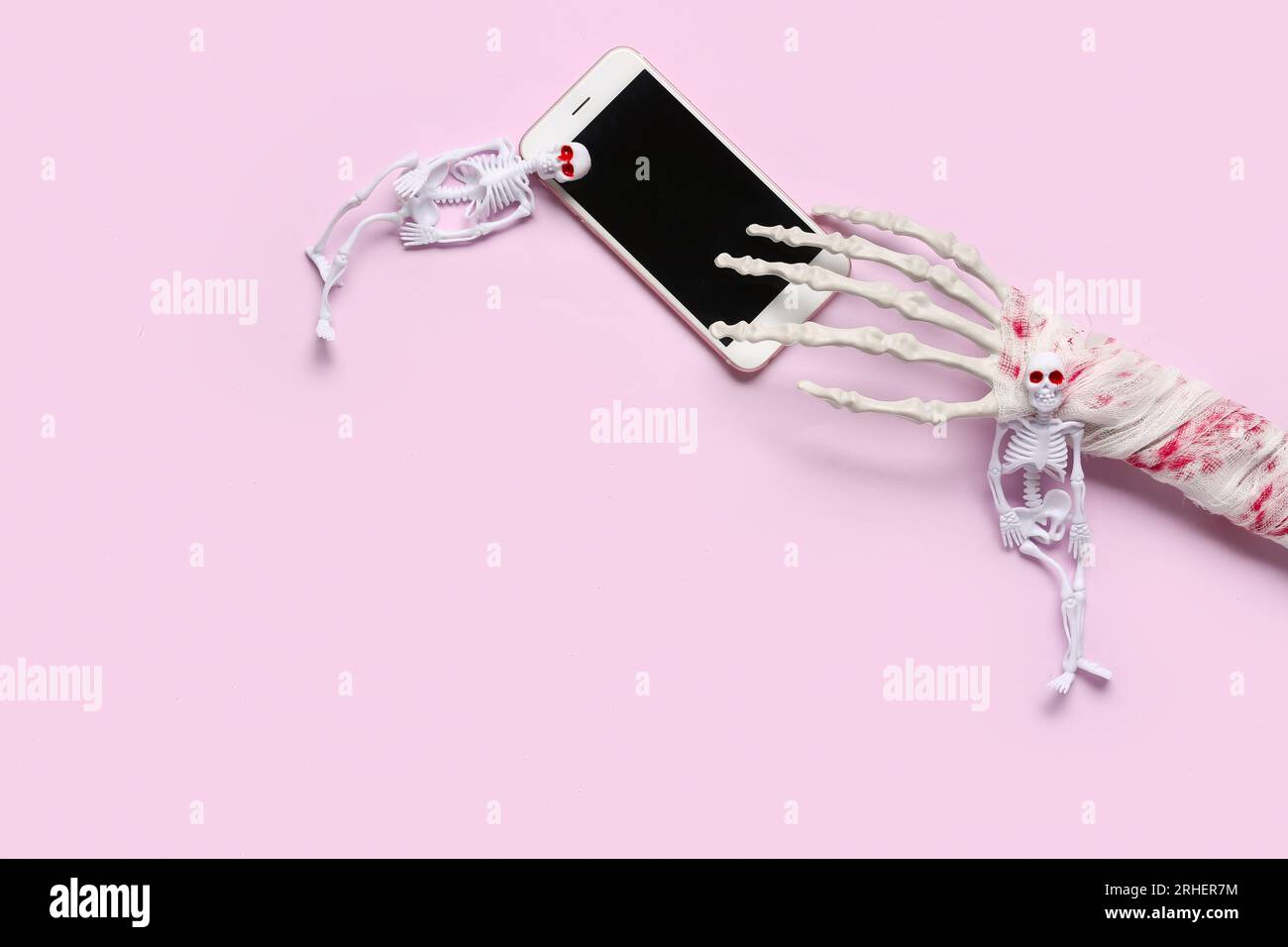 Skeletons with hand and modern mobile phone for Halloween celebration ...