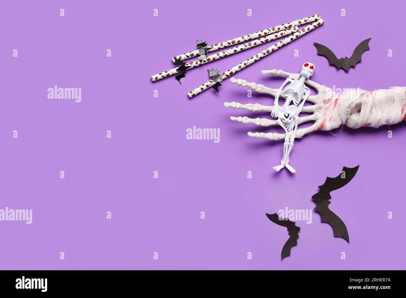 Skeleton with hand, straws and paper bats for Halloween celebration on ...