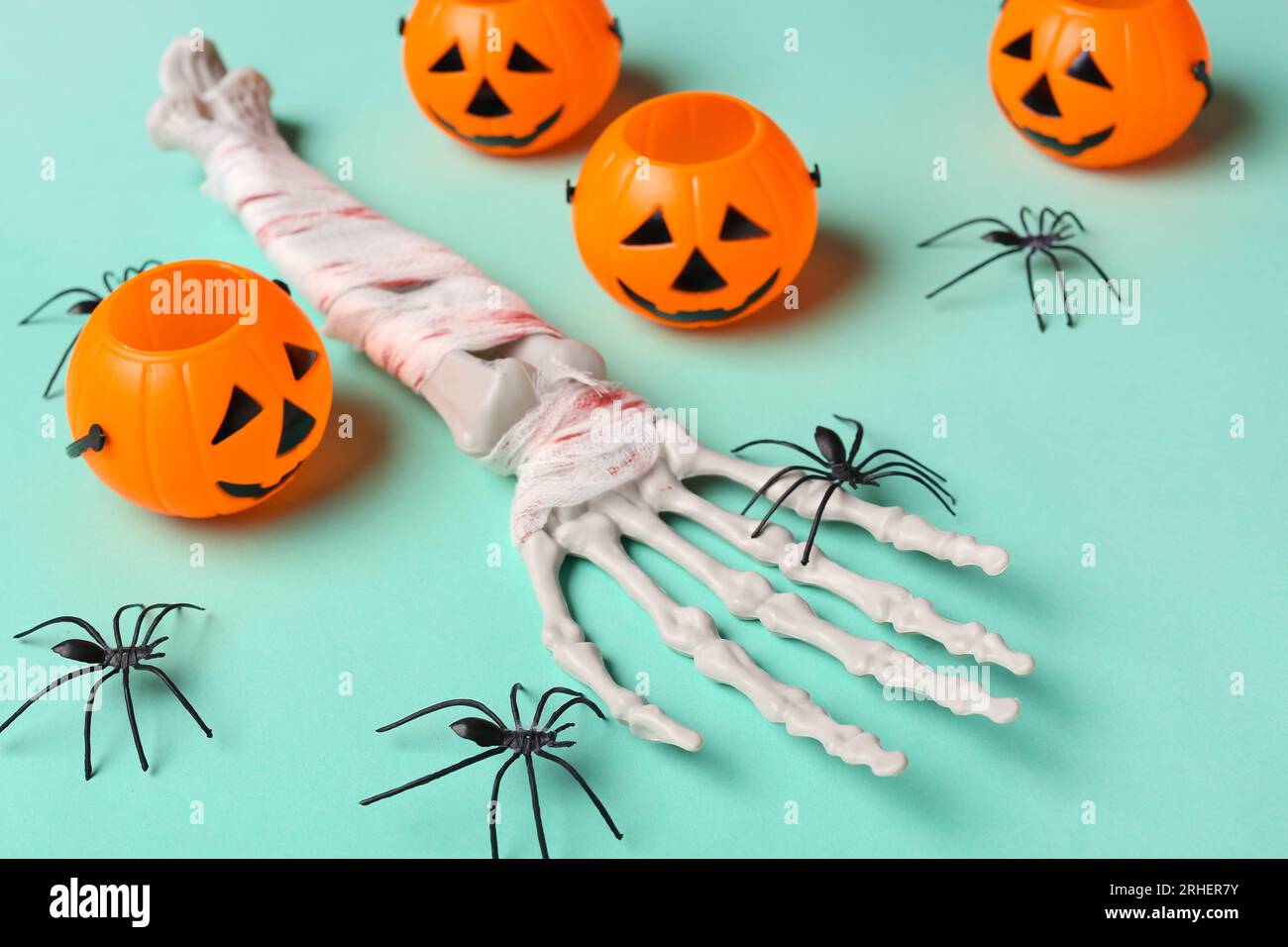 Skeleton hand with pumpkins and spiders for Halloween celebration on ...