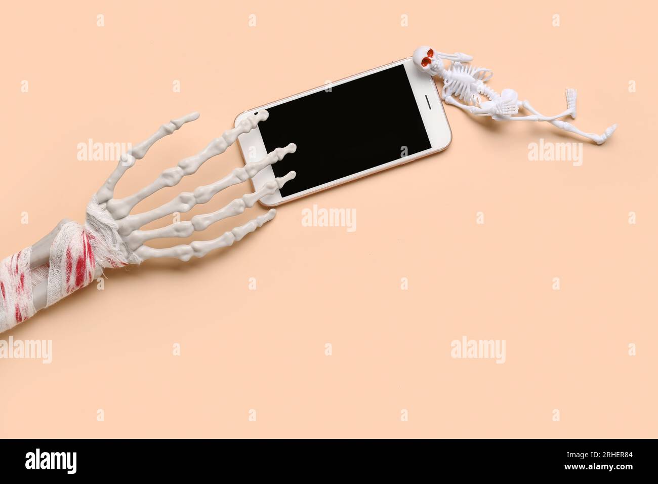 Skeleton with hand and modern mobile phone for Halloween celebration on ...