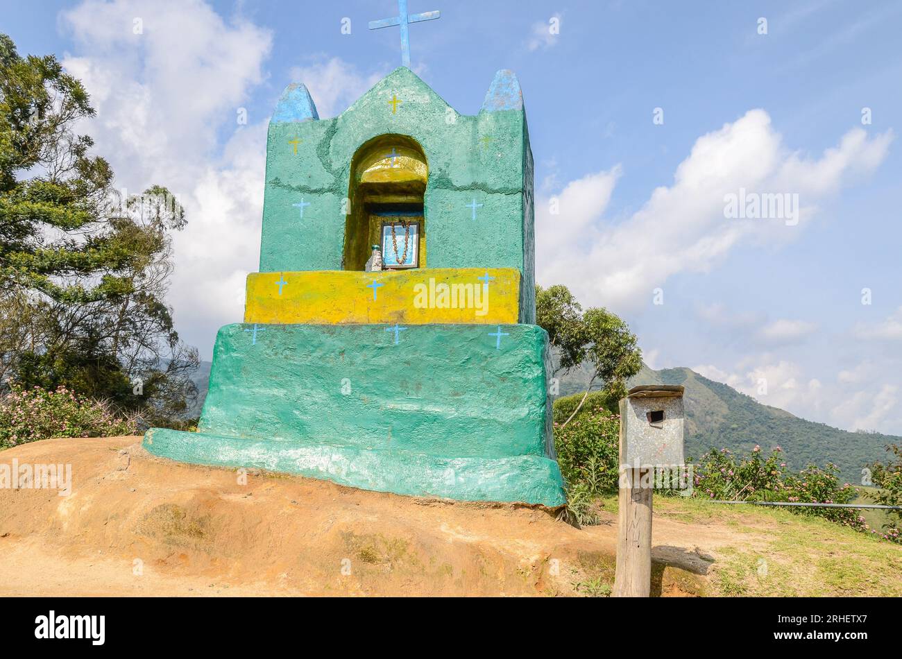 A cross, statue of Mother Mary with Infant Jesus and portrait of St ...