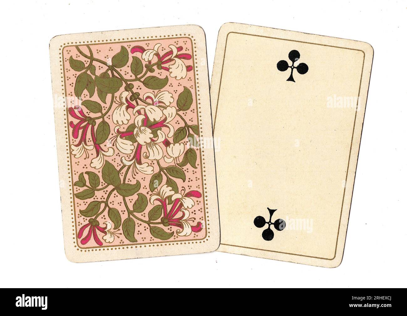 A pair of antique playing cards with the two of clubs revealed on a ...
