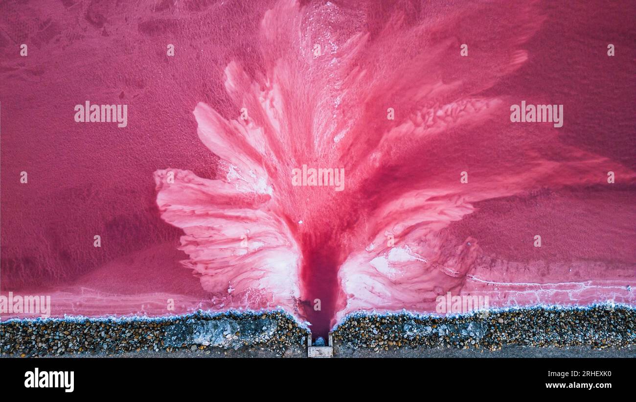 Aerial view of pink salt lake. Salt production plants evaporated brine ...