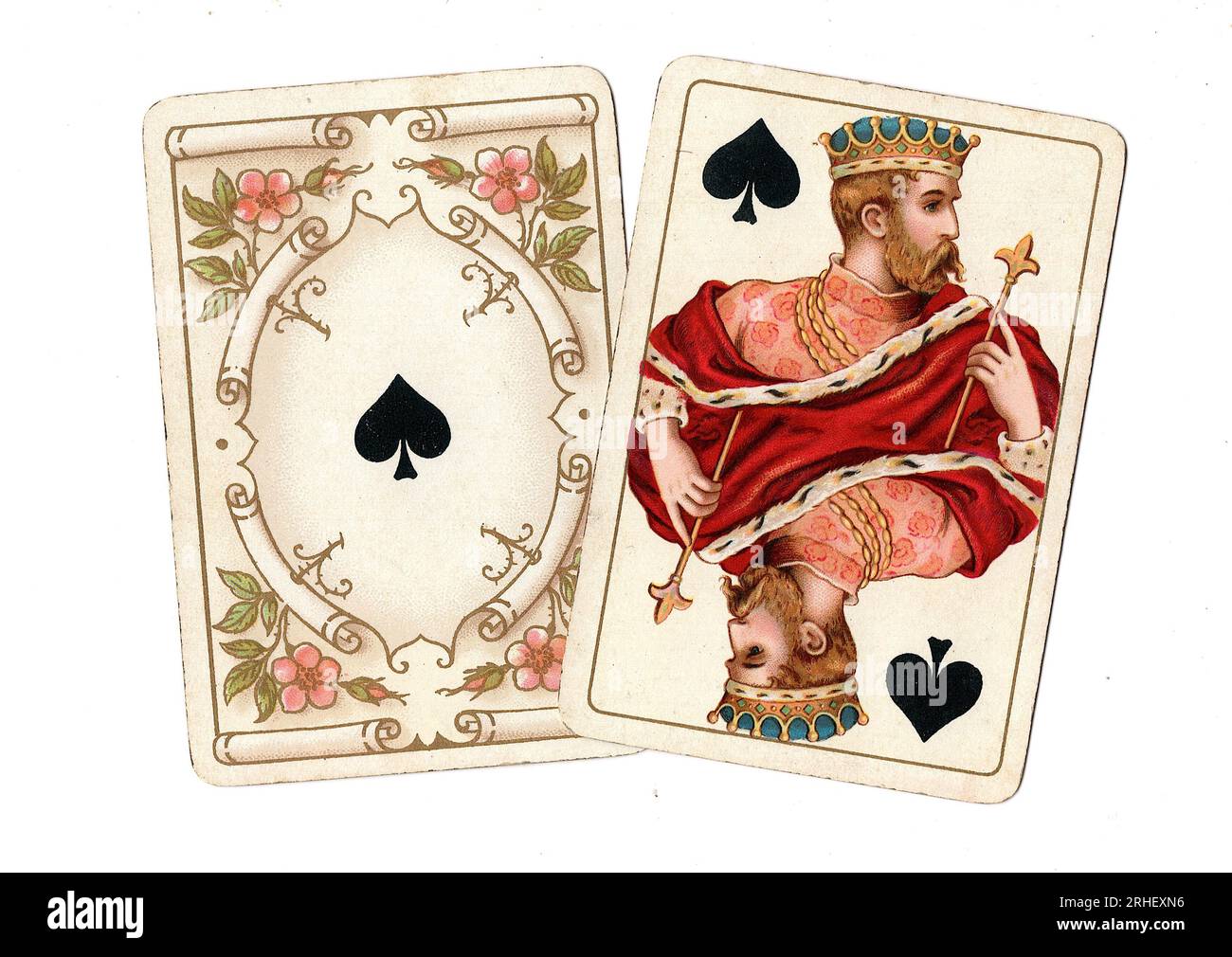 A pair of antique playing cards showing an ace and king of spades on a ...