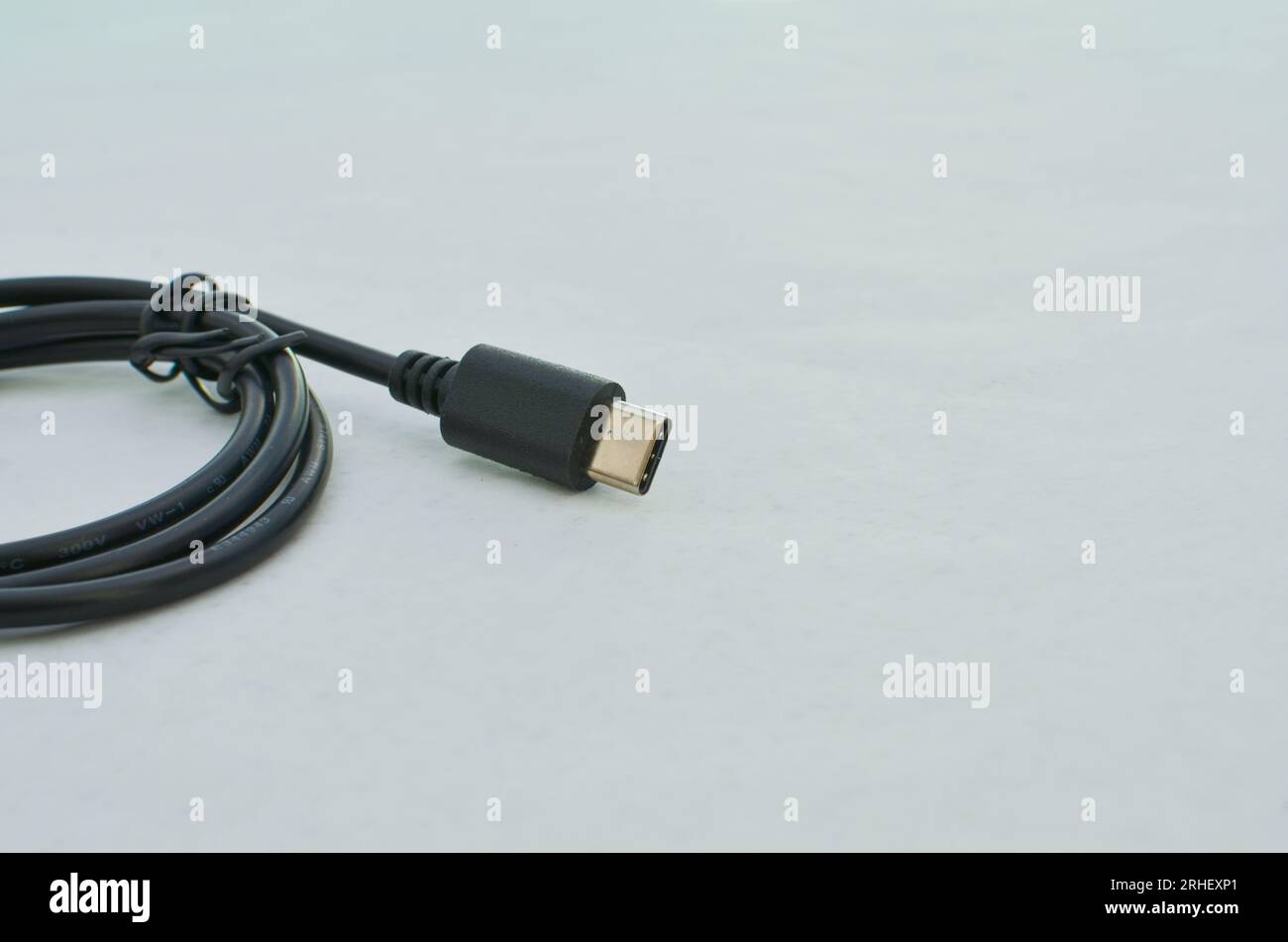 Black USB Type-C cable detail highlighted on a clear surface, perfect ...