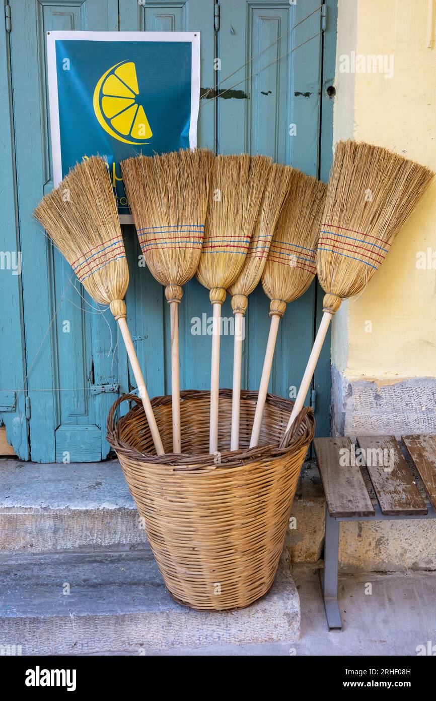 Traditional hand made brooms and a woven wicker baskest for sale on the ...