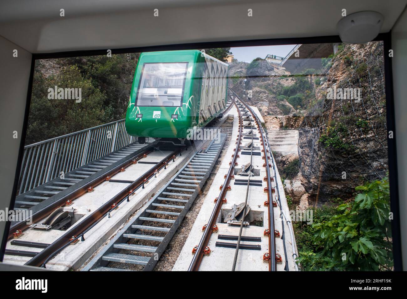 Santa Cova cable car railway train climbing up Santa Cova chapel on the ...