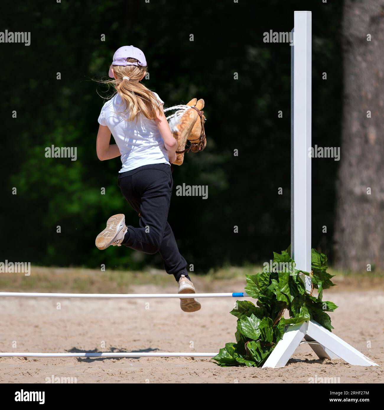 Girl riding stick horse hi-res stock photography and images - Alamy