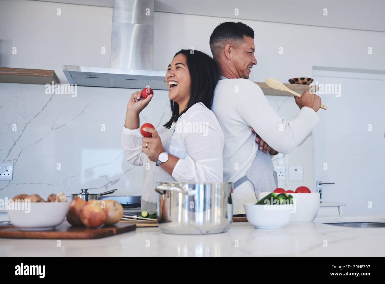 Happy couple, food and fun cooking in kitchen together for healthy ...
