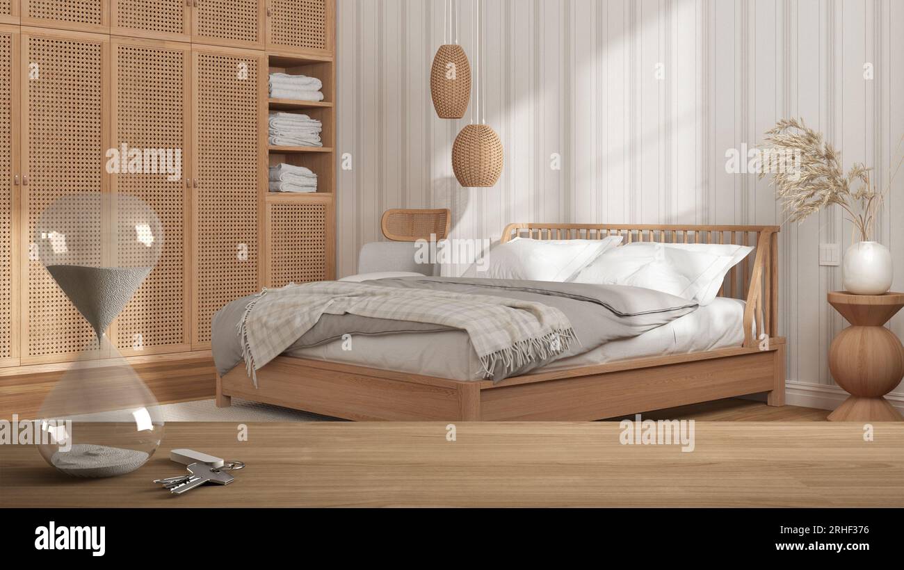 Wooden table or shelf with crystal hourglass measuring the passing time over modern bedroom with ...