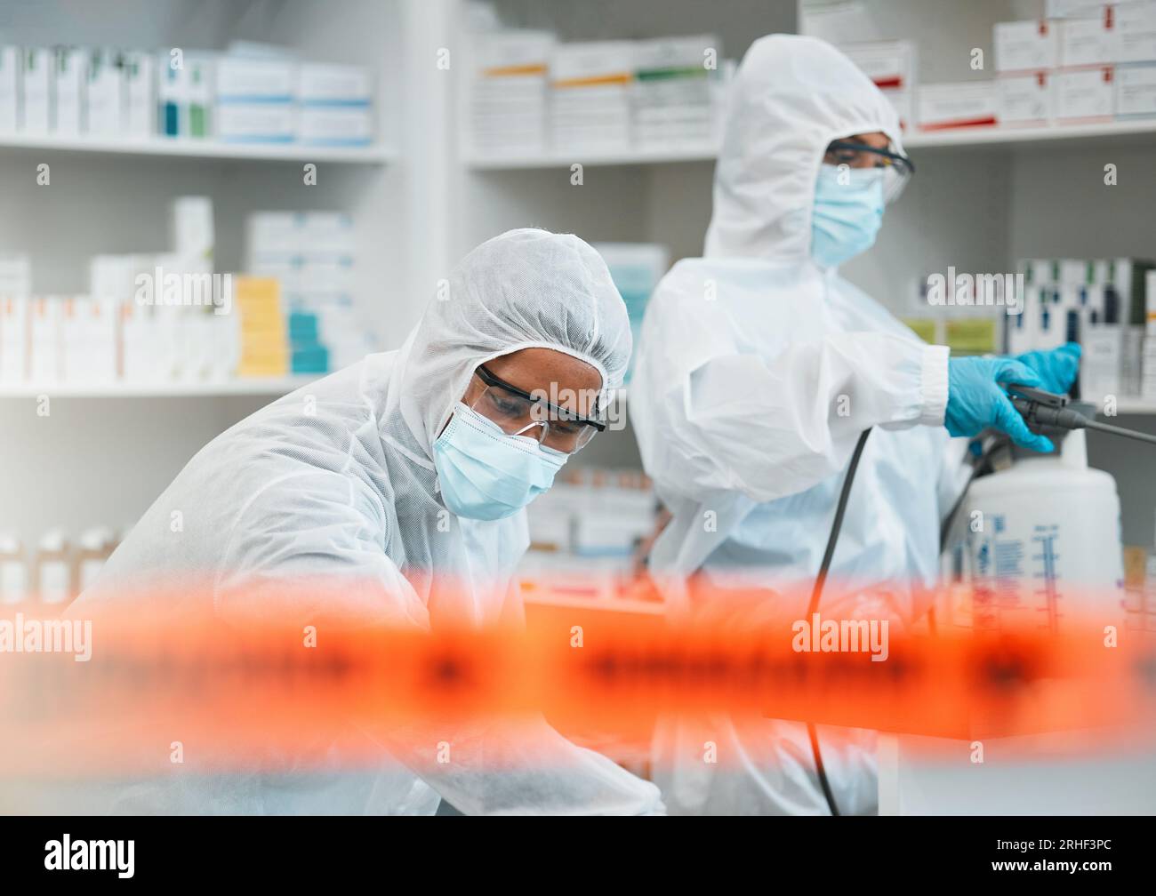 Pharmacy disinfection, red tape and people spray chemical solution for ...