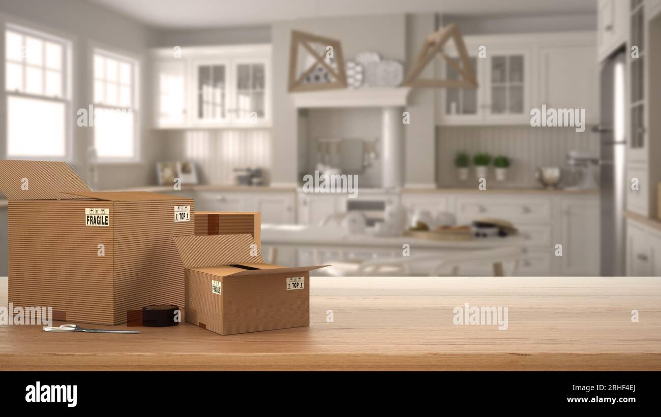 Wooden table, desk or shelf with stack of cardboard boxes over blurred ...