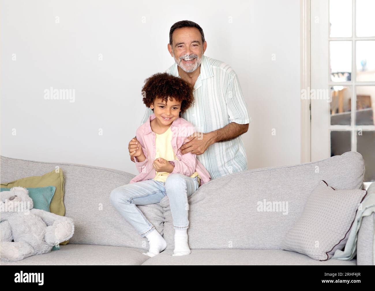 Happy Hispanic Grandfather Hugging And Cuddling With Grandchild Boy ...
