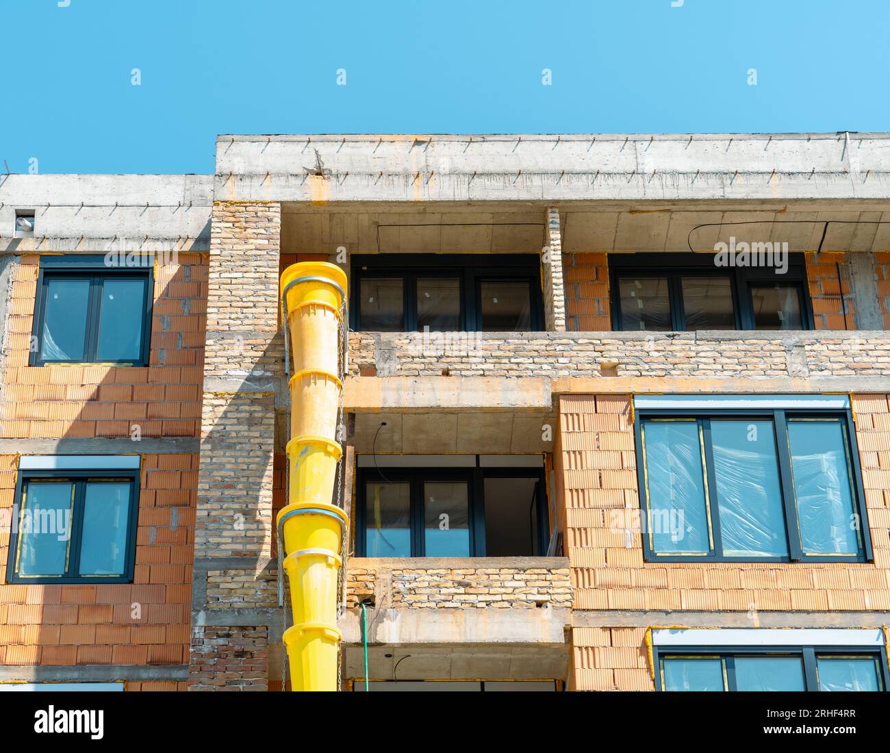 Yellow plastic dumping tubes for debris, construction waste at ...