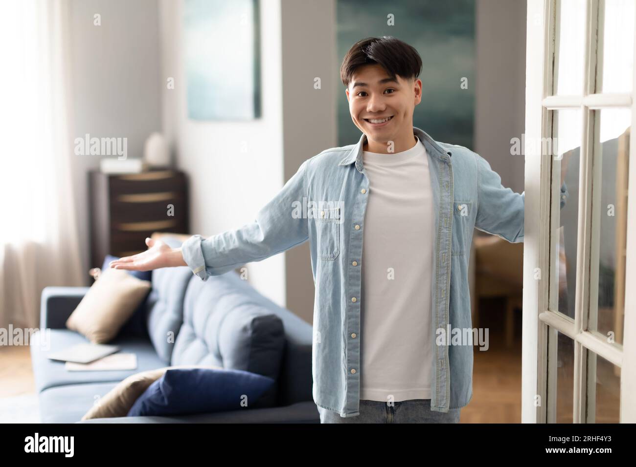 Asian Guy Opening Door Meeting You Inviting To His Home Stock Photo - Alamy