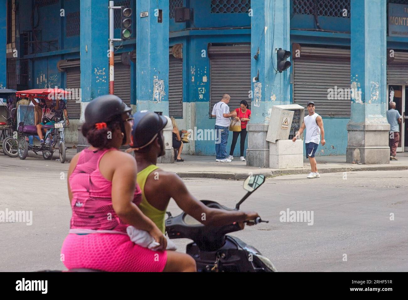 Havana, Cuba, a couple drives an electric bicycle or e-bike on an empty ...