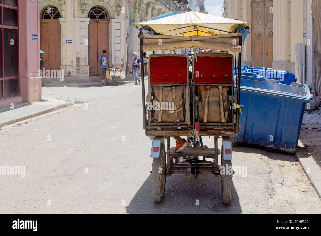 Havana, Cuba, rear view of a bicitaxi or pedicab driving by large ...