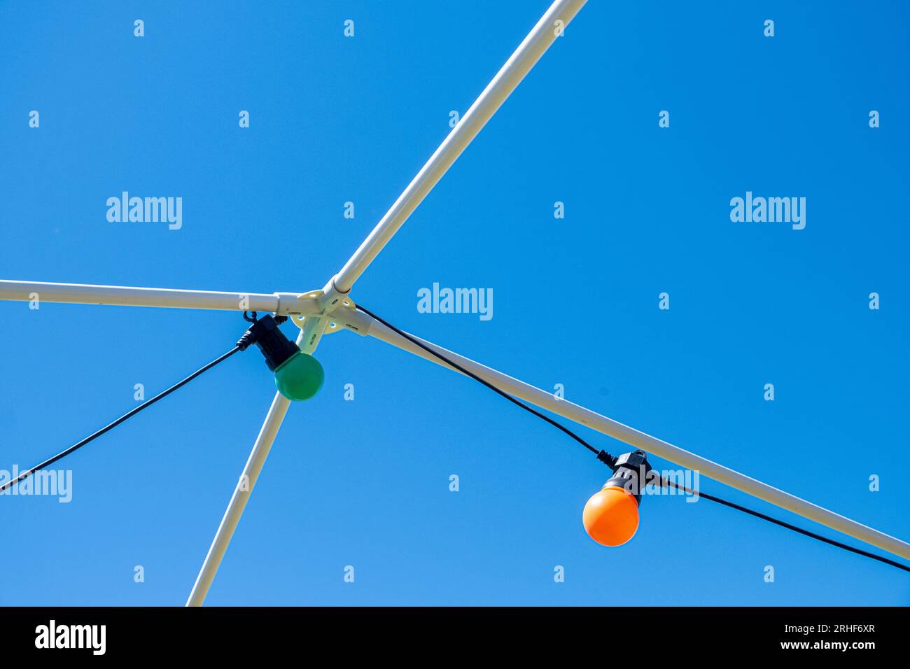 colored bulbs hanging from a pergola Stock Photo - Alamy