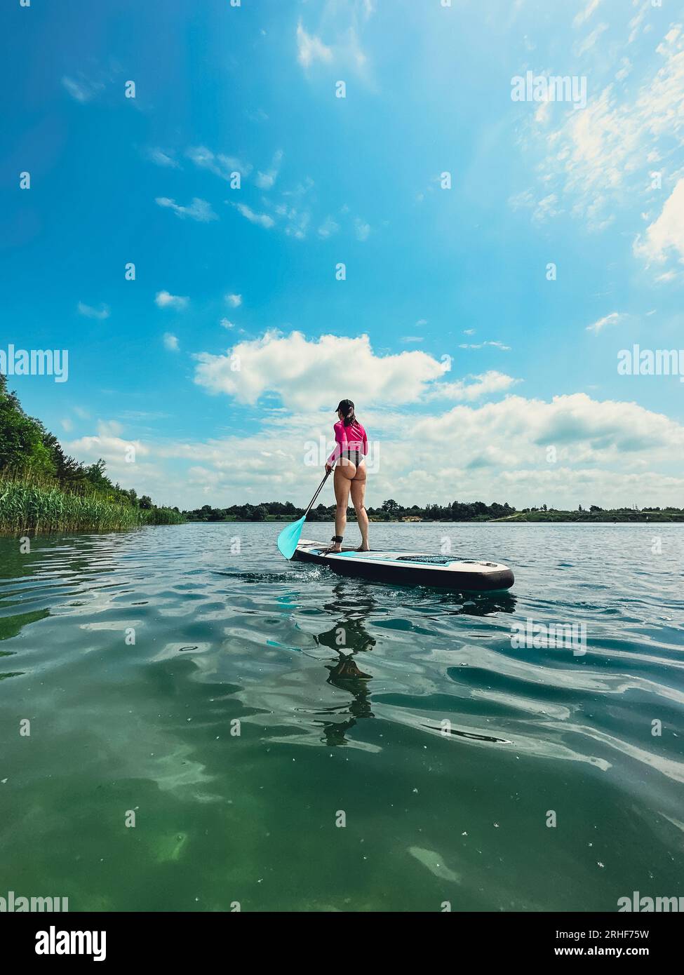 standing woman on supboard Stock Photo - Alamy