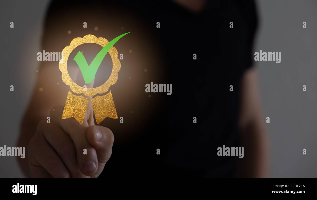 Businessman touching virtual screen icon of the best quality assurance. The check mark symbol ...