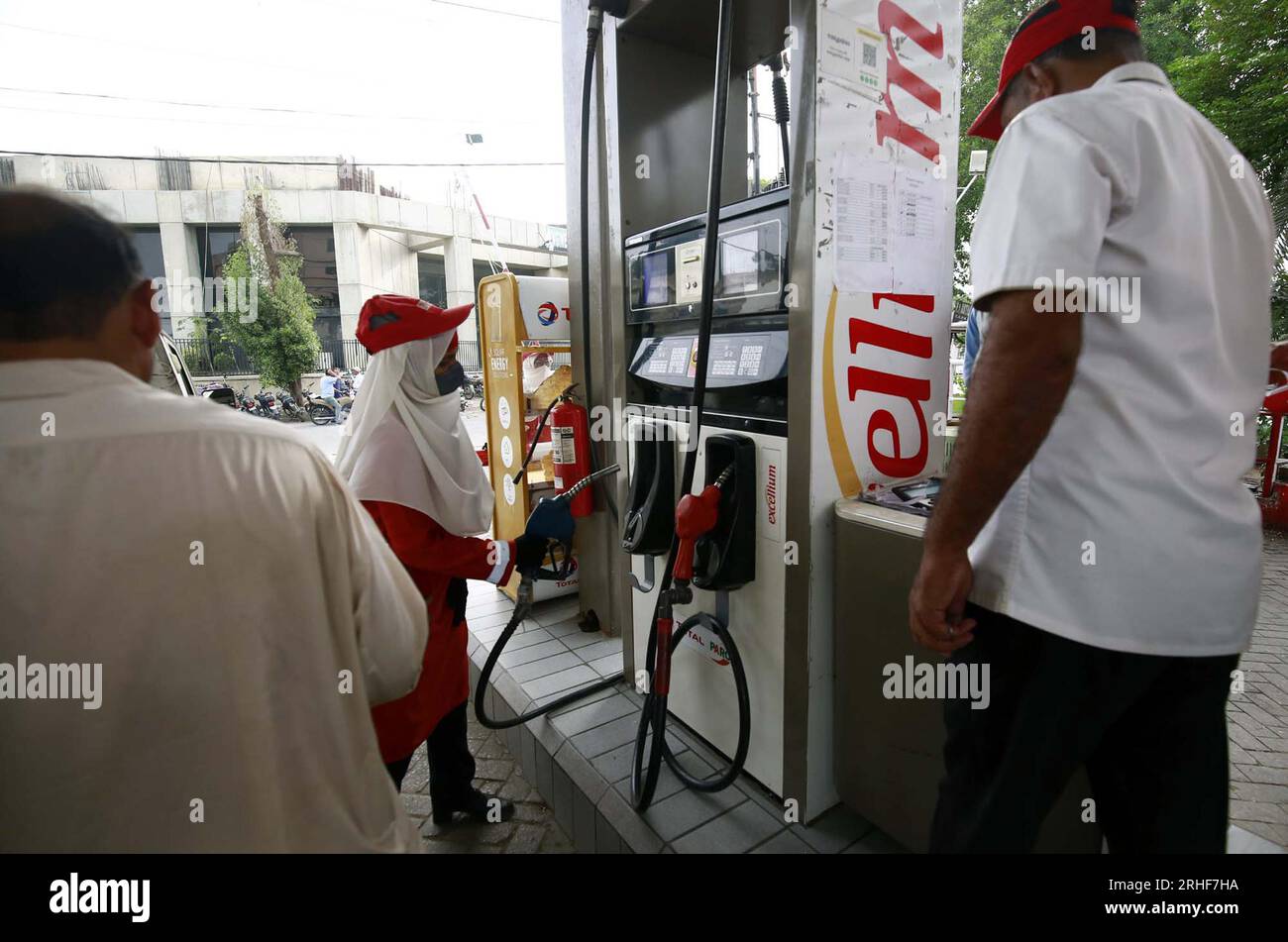Karachi, August 16, 2023. Fuel station worker filling petrol in vehicle, at Fuel Station in ...