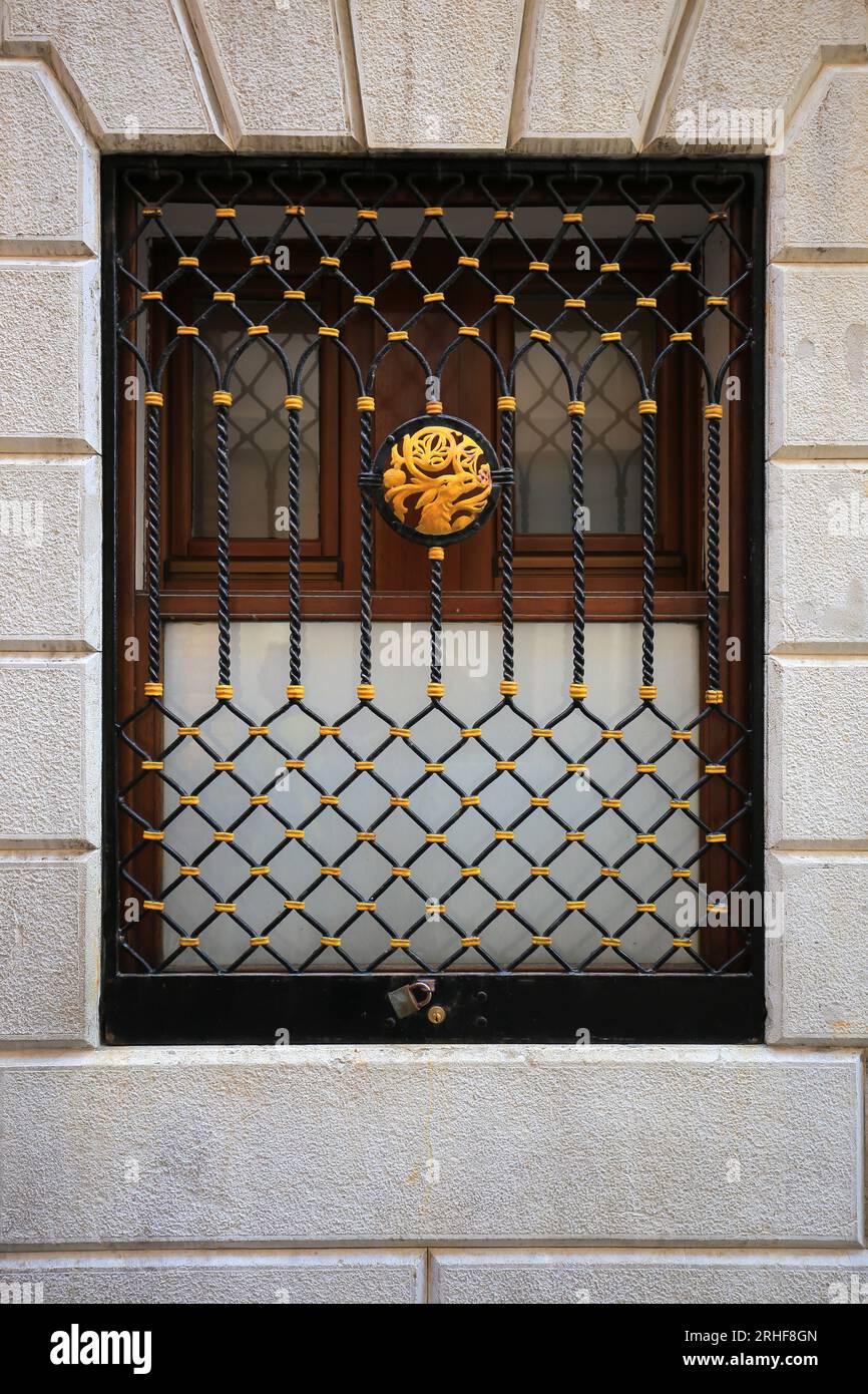 Beautiful wooden window with wrought iron lattice with patterns in ...