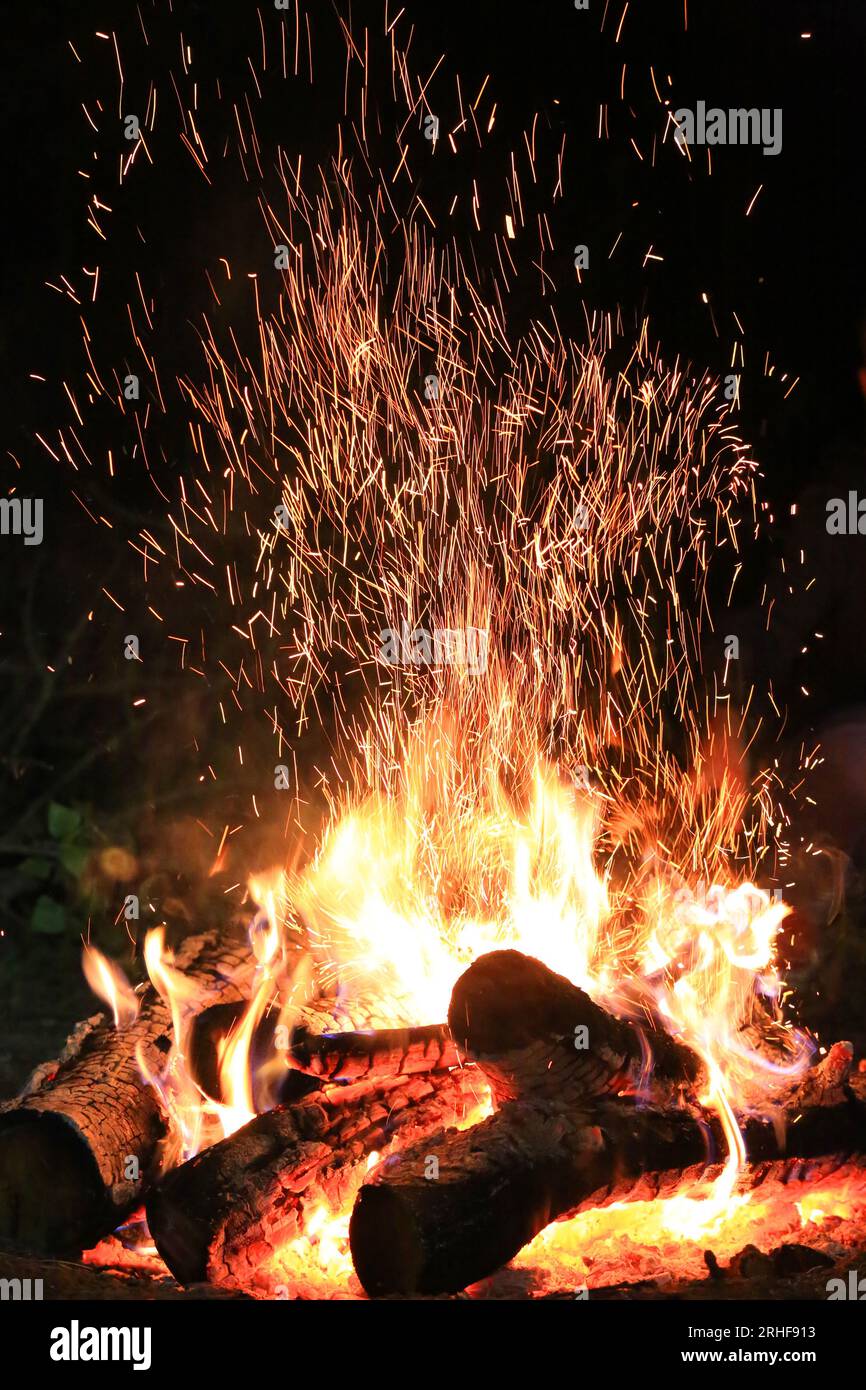 sparks over blazing campfire wood in the dark Stock Photo - Alamy