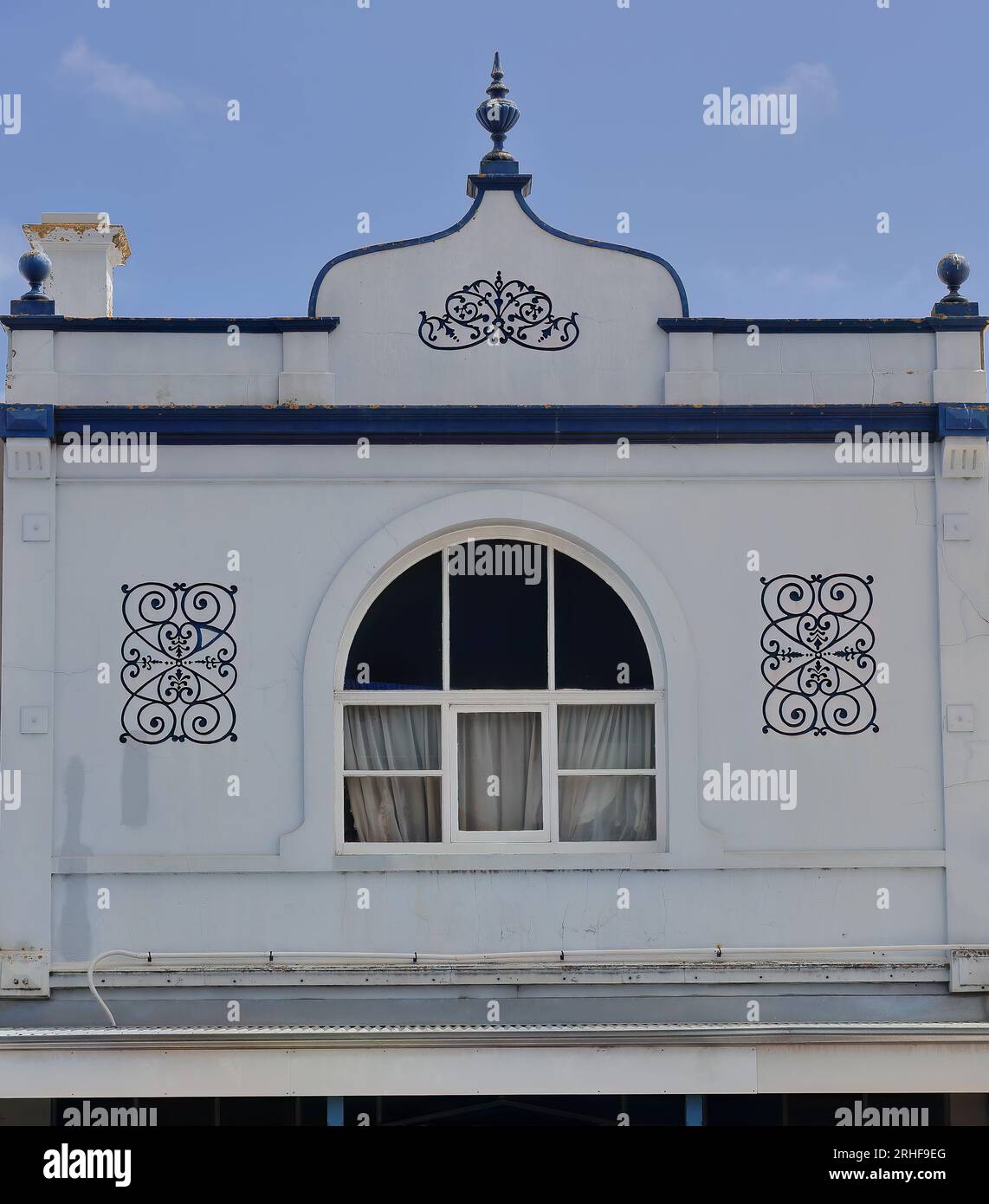 848 White facade of Victorian commercial terrace showing blue arabesque ...