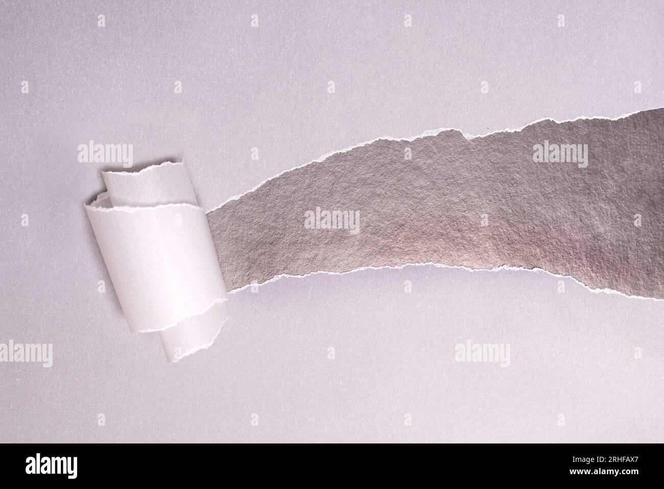 Torn paper with opening showing black background Stock Photo - Alamy