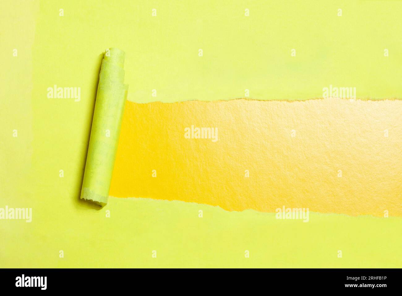 Torn paper with opening showing yellow background Stock Photo - Alamy