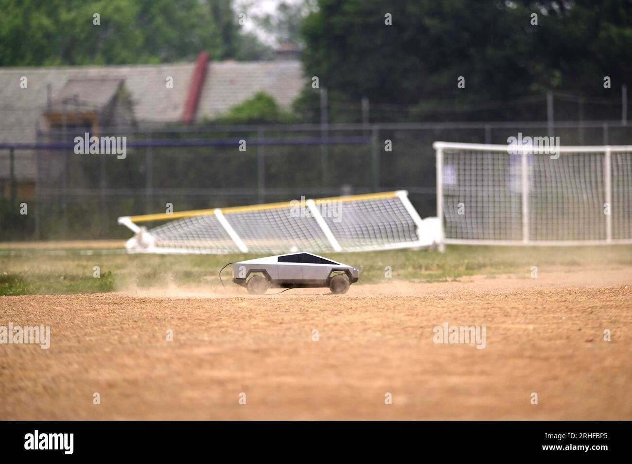 RC Cybertruck stirs dust on a baseball infield, its aimless path a ...