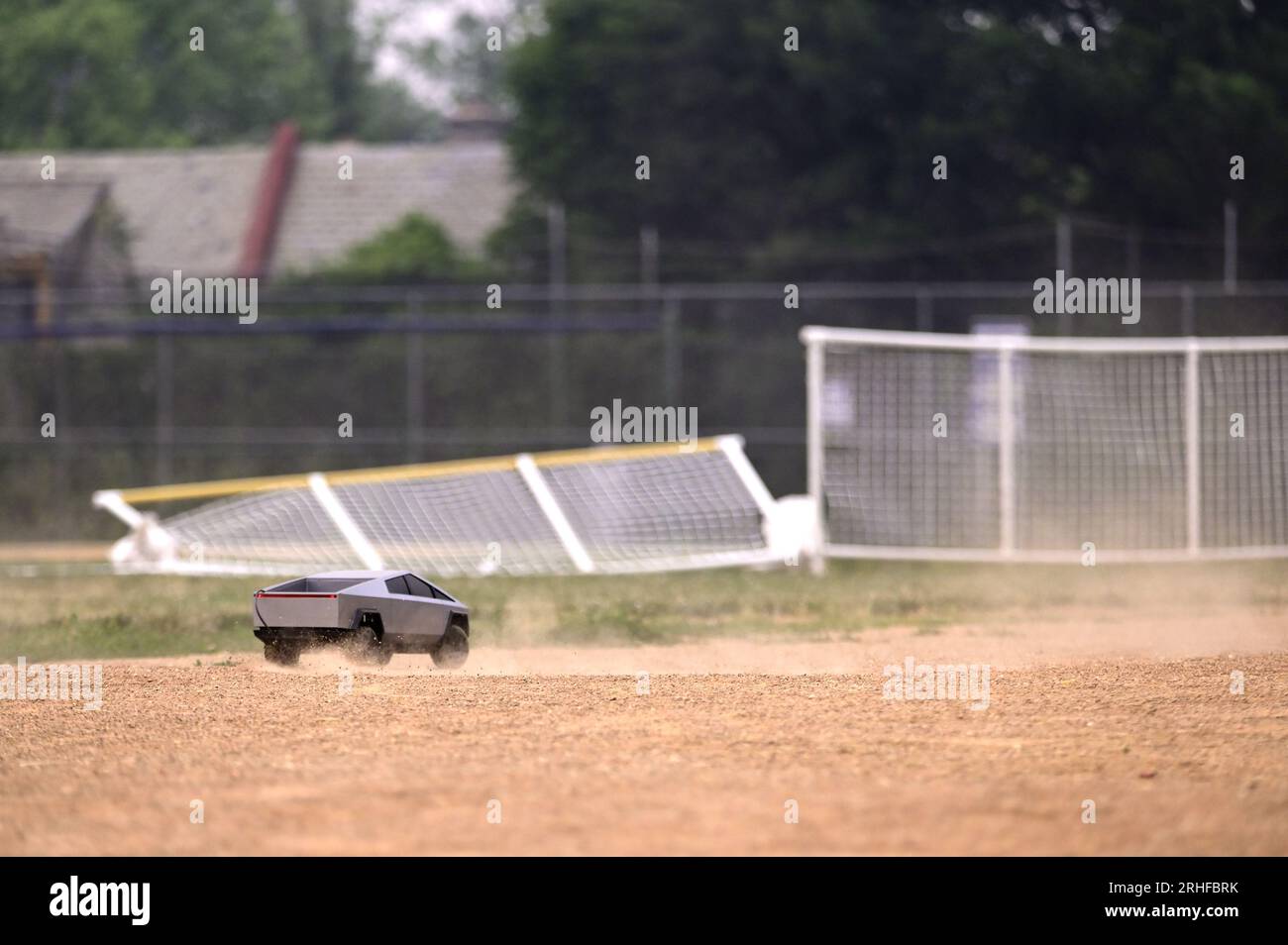RC Cybertruck stirs dust on a baseball infield, its aimless path a ...