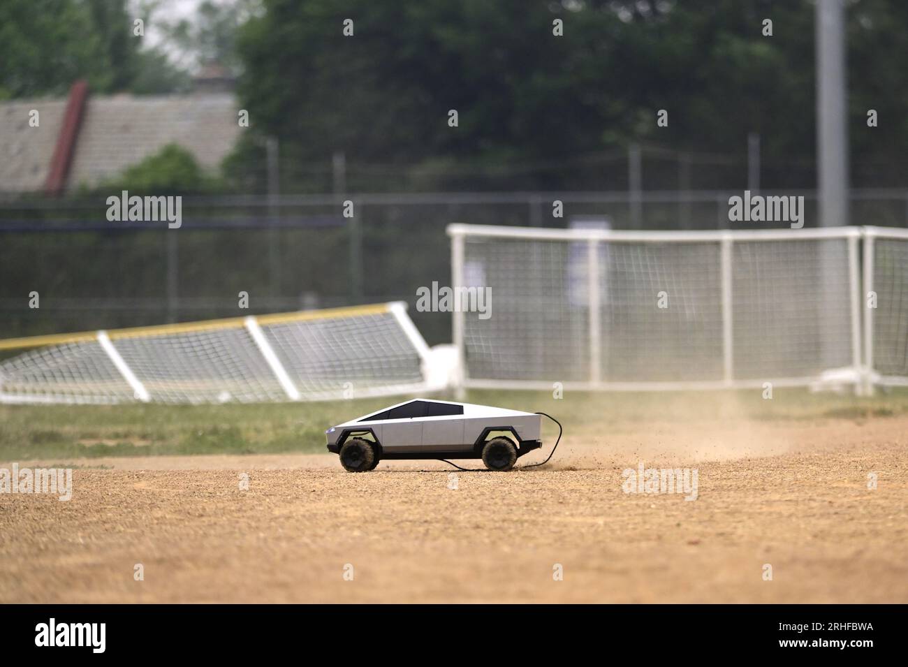 RC Cybertruck stirs dust on a baseball infield, its aimless path a ...