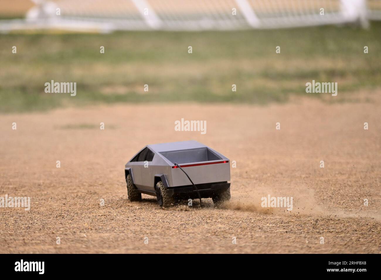 RC Cybertruck stirs dust on a baseball infield, its aimless path a ...