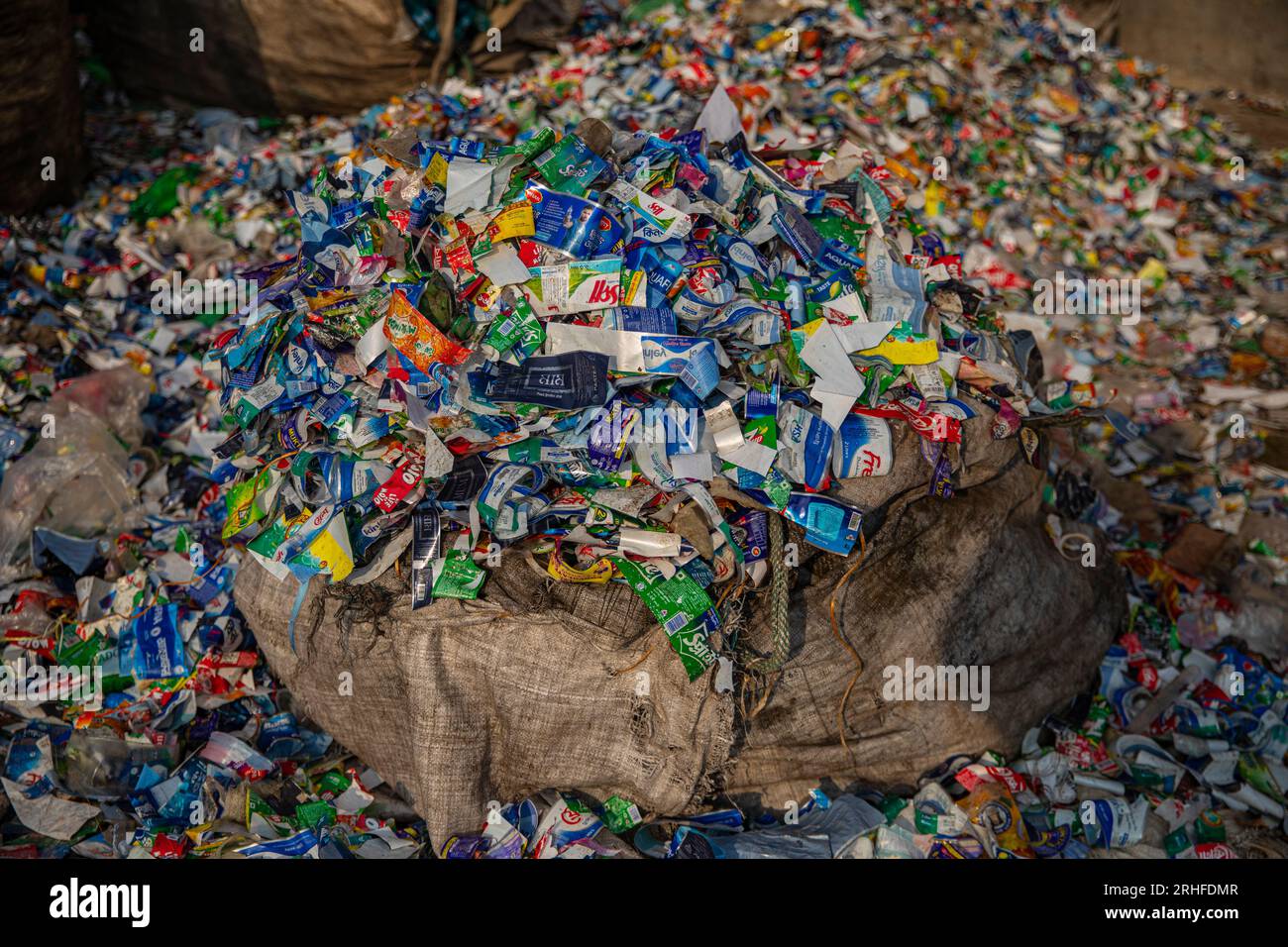 Different pet bottle's labels and food wrappers dumped beside a plastic ...