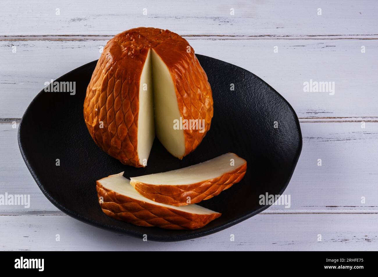 smoked provolone made with buffalo milk and slices Stock Photo - Alamy