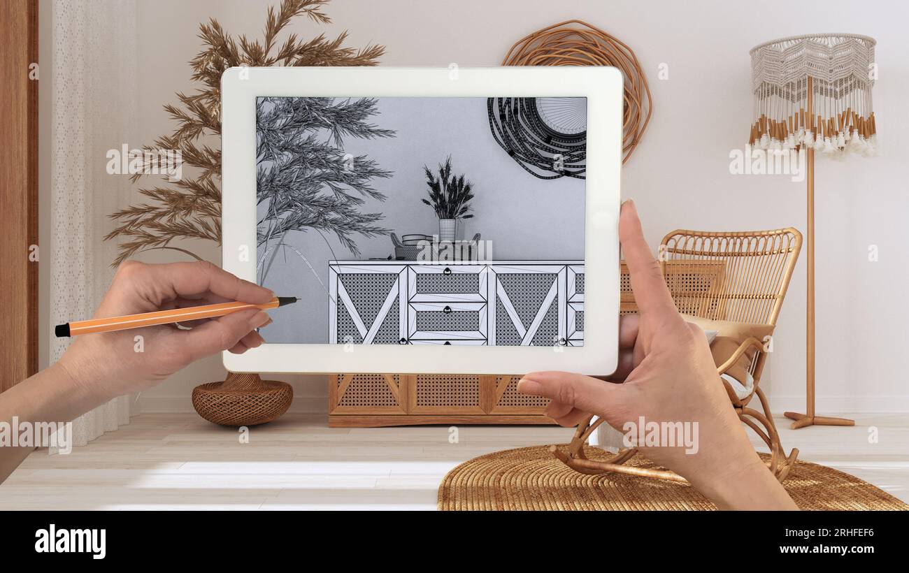 Hands holding and drawing on tablet showing bohemian living room in ...