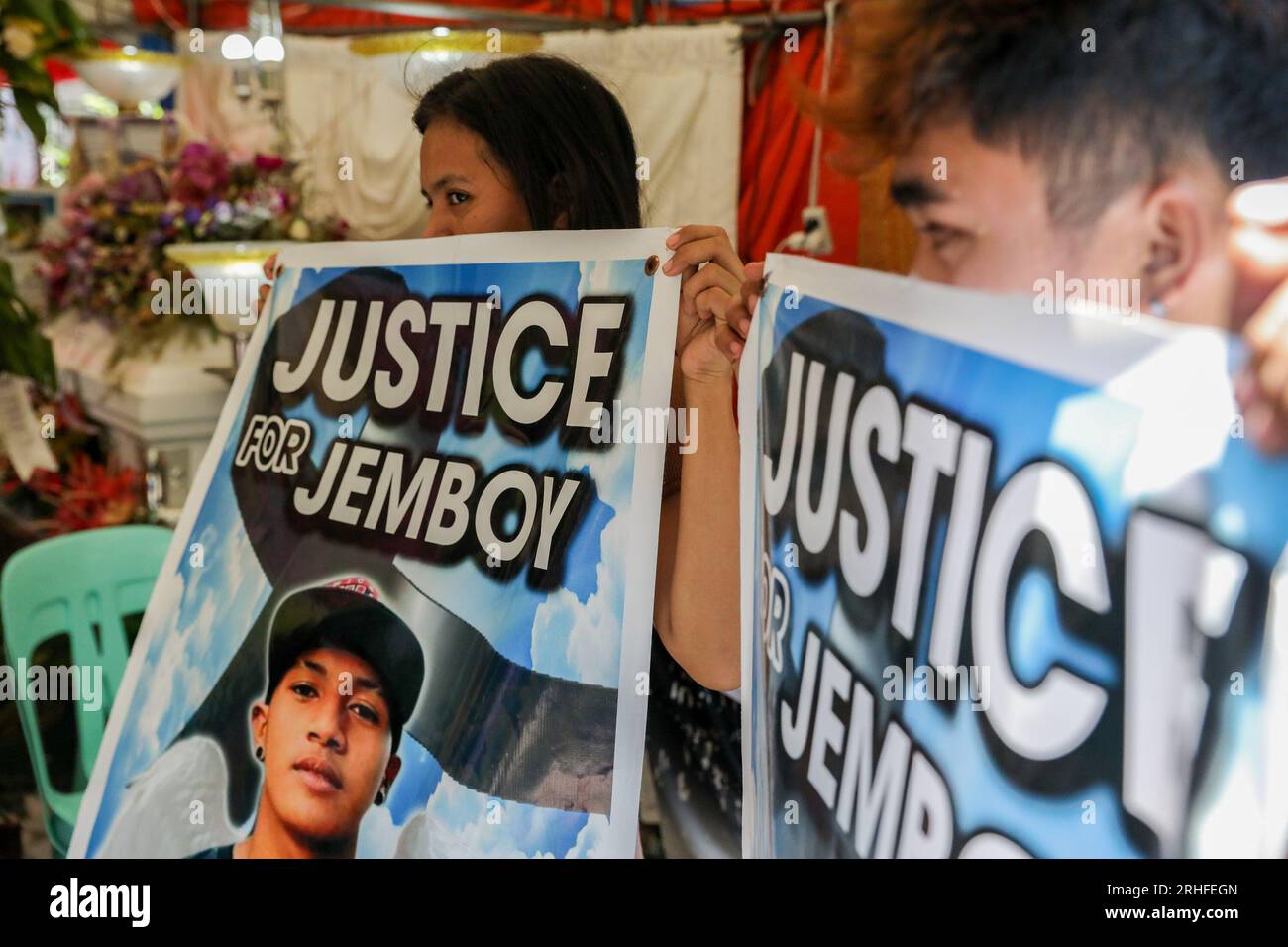 Manila, Philippines. 16th Aug, 2023. Friends and relatives of Jemboy Baltazar hold signs calling ...