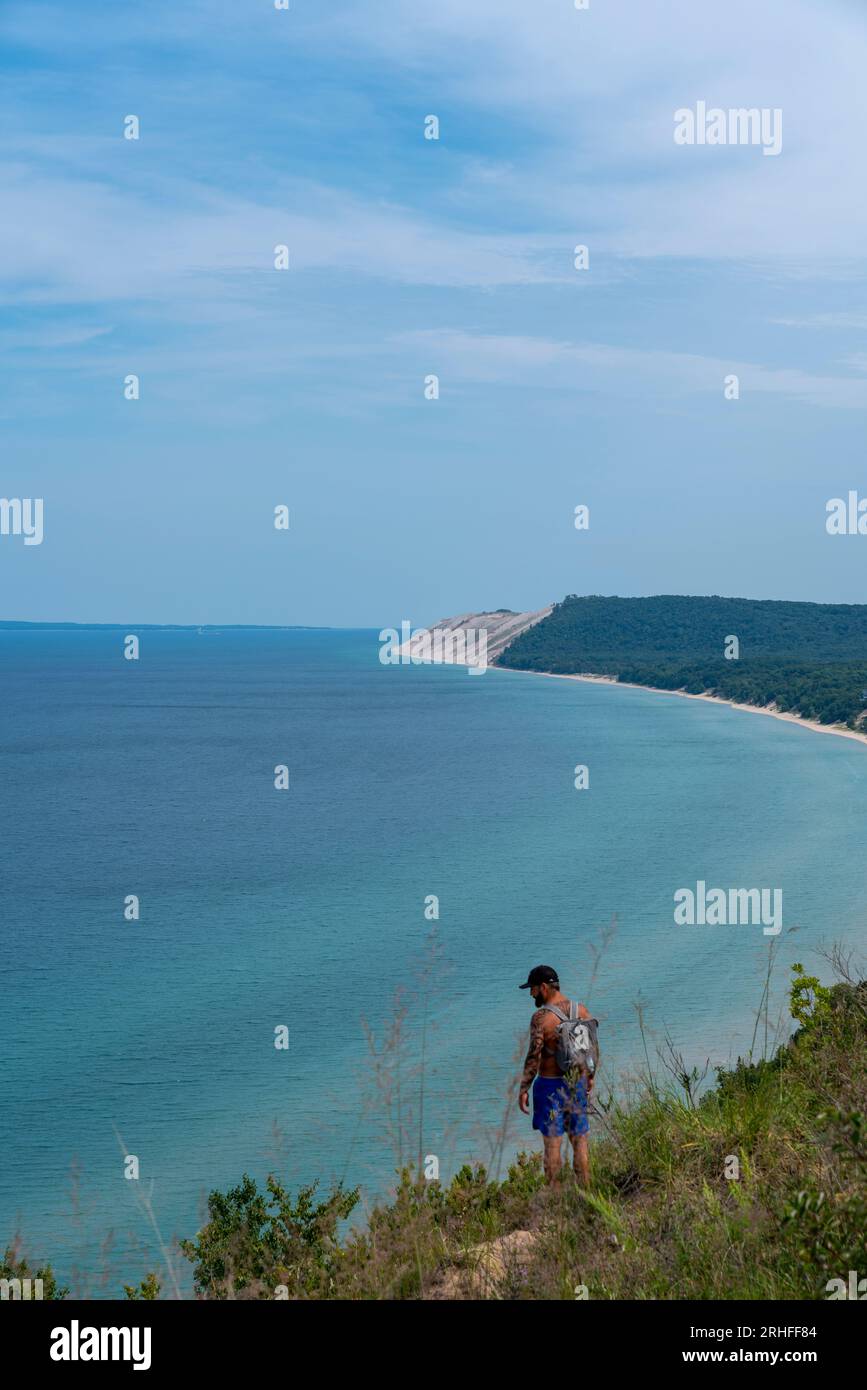 Hiker at Sleeping Bear Dunes National Seashore with Lake Michigan from Empire Bluffs, Michigan ...
