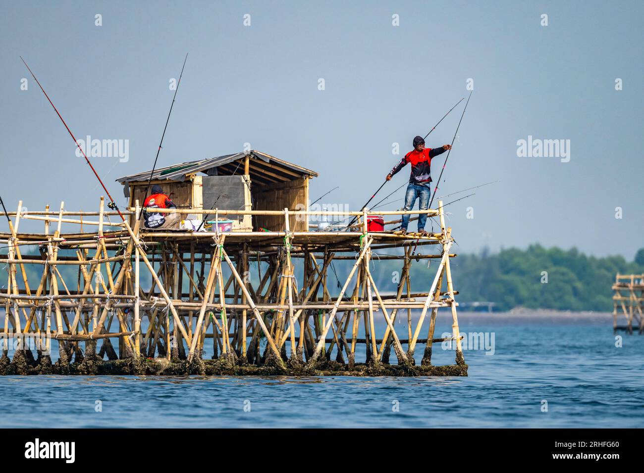 Local people fishing on bamboo plateform standing above water. Java ...